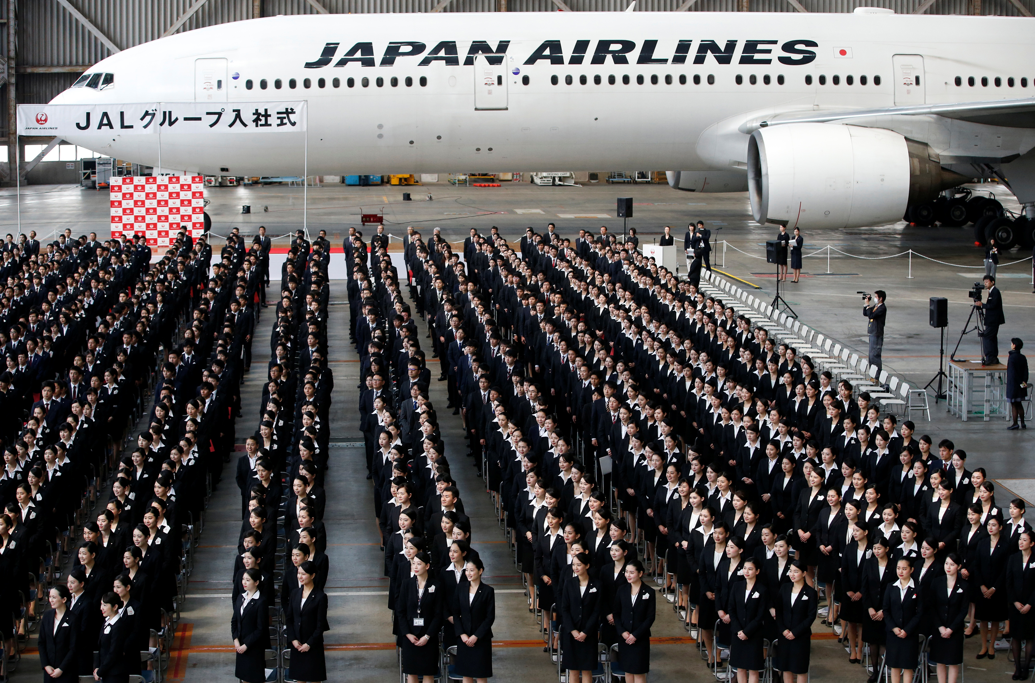 Newly-hired employees of Japan Airlines group attend the company group ...